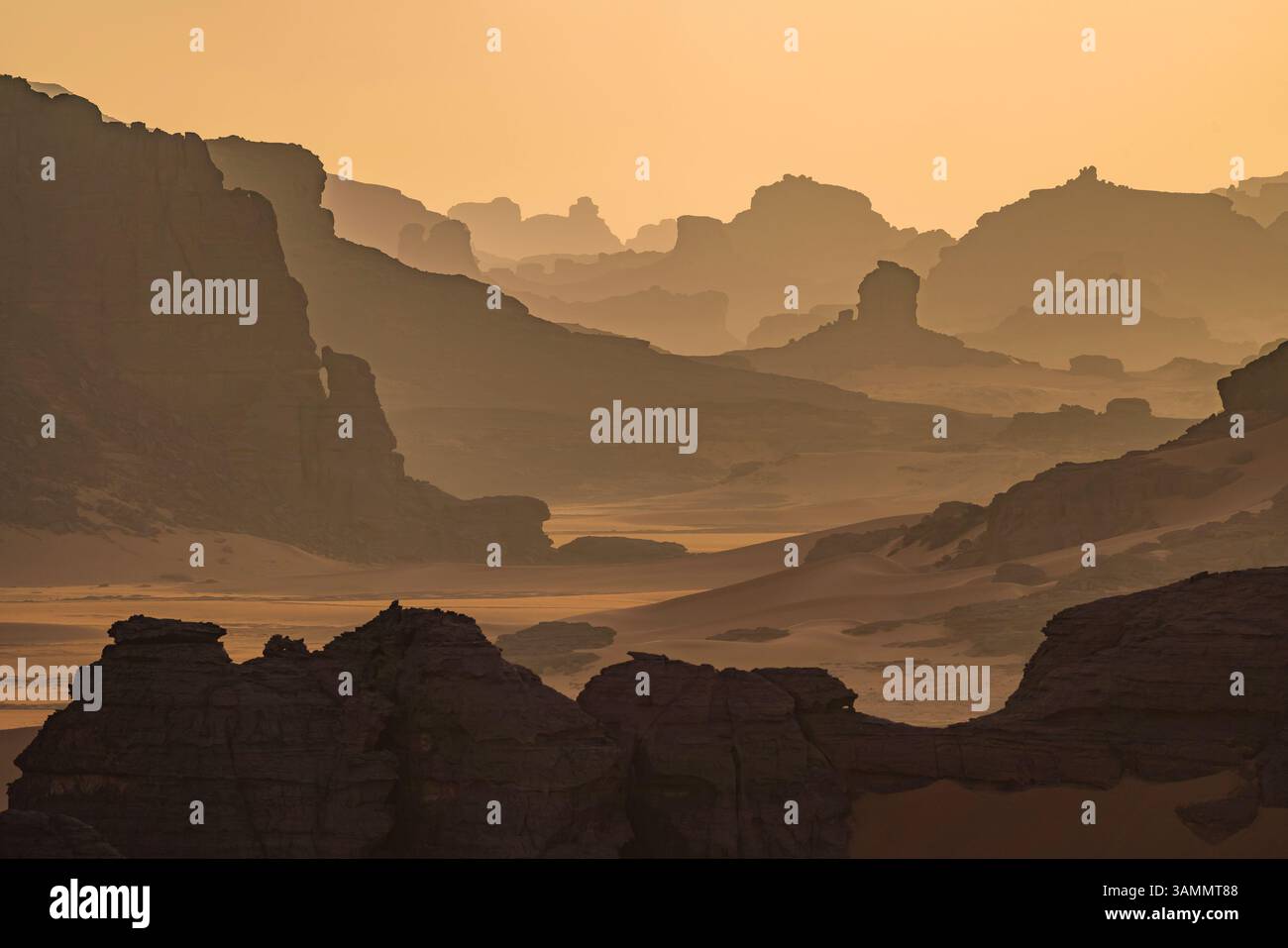 Aerial View of rock formations among sand dunes at sunset in the Sahara ...