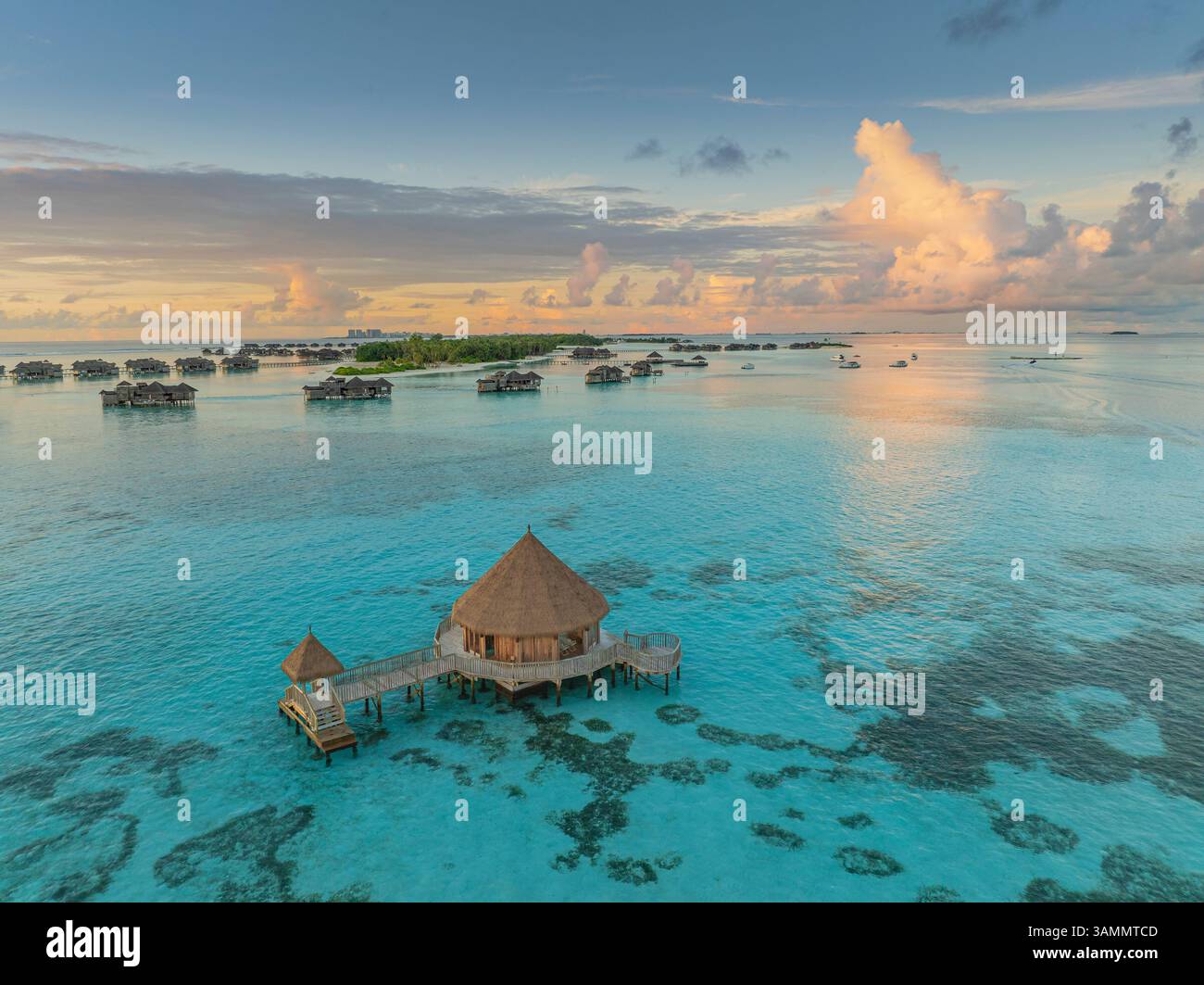 Aerial view of idyllic luxury bungalows on a tropical island surrounded ...