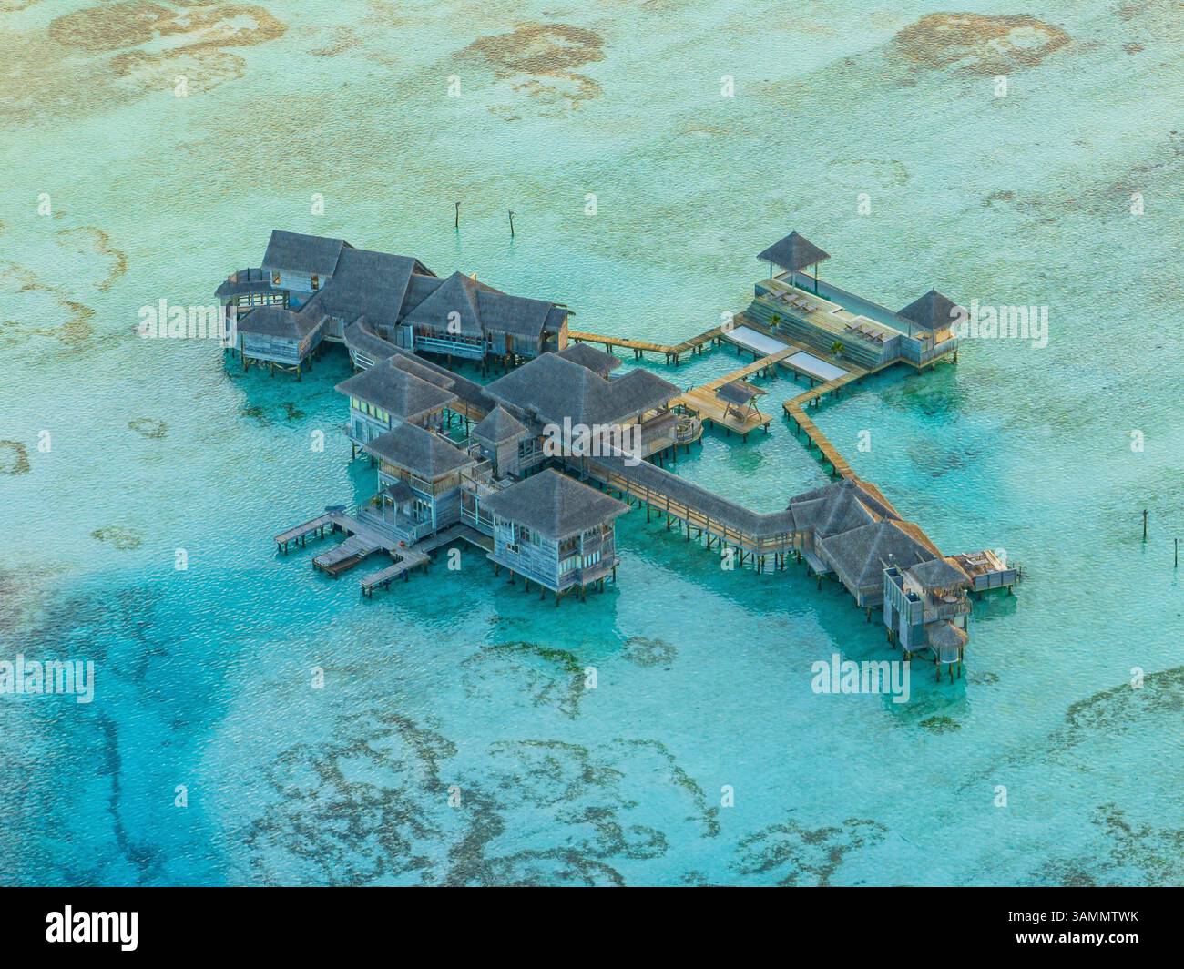 Aerial view of beautiful overwater bungalows and turquoise water in a ...