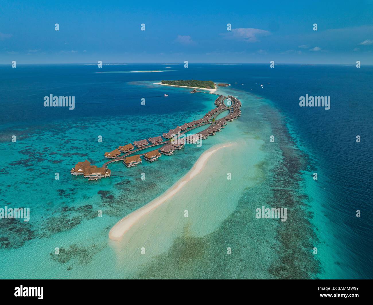 Aerial view of Muravandhoo Island with luxury resort and beautiful turquoise ocean, Raa Atoll ...