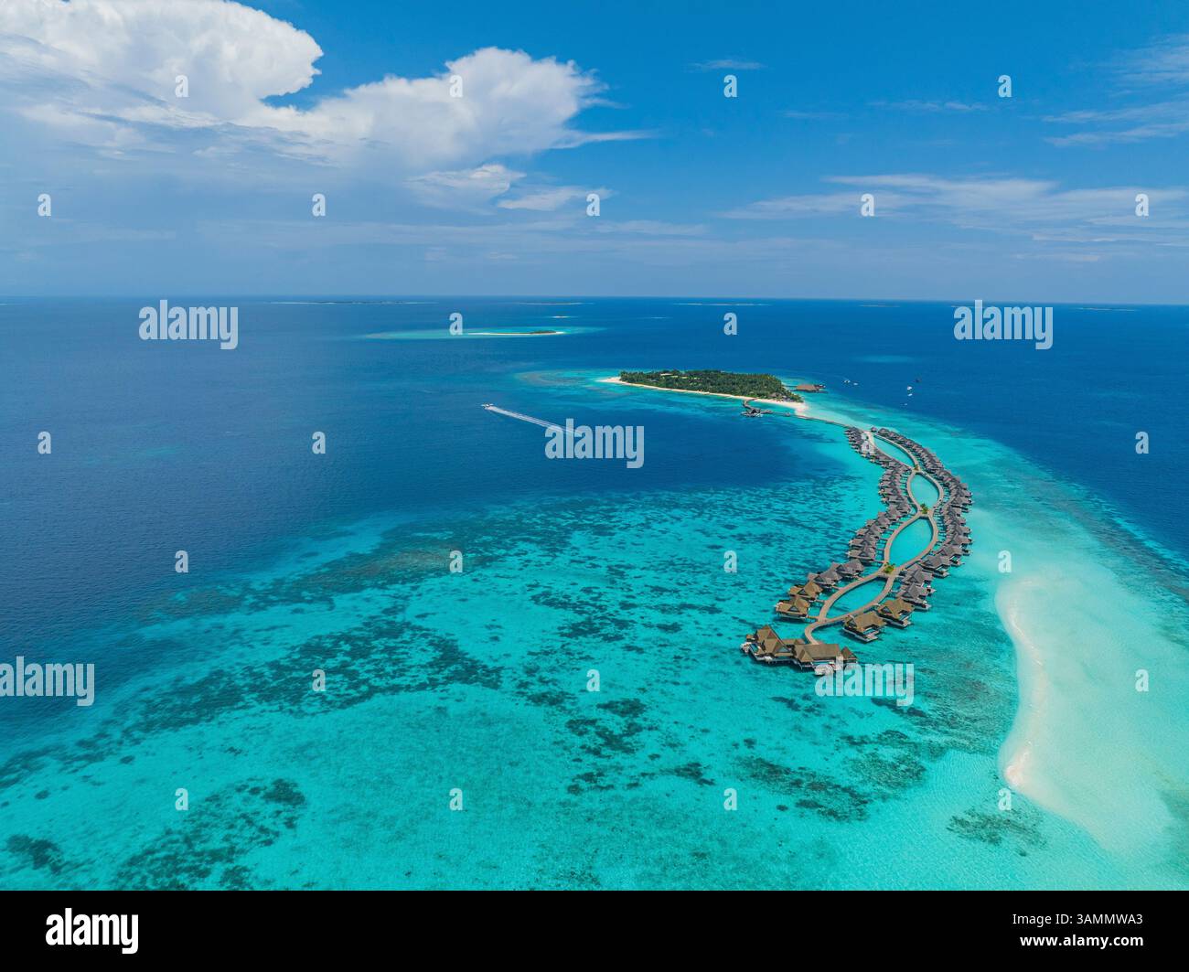 Aerial view of luxurious bungalows on a beautiful tropical beach with ...