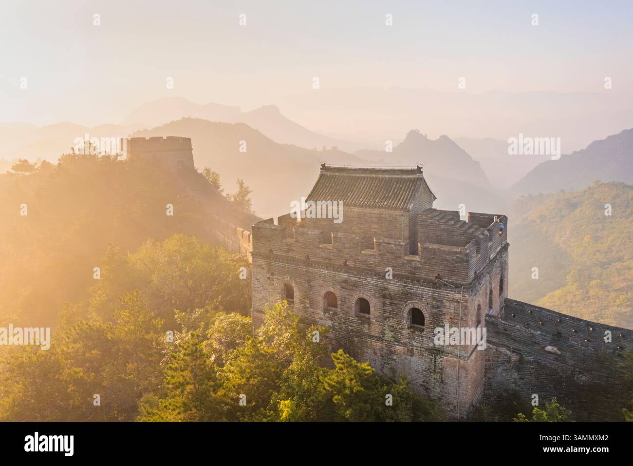 Aerial view of the majestic Jinshanling Great Wall amidst misty ...