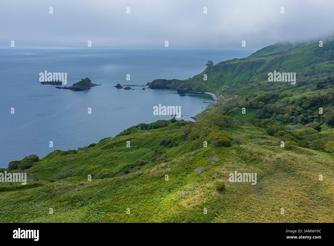 Aerial view of Moneron island with green hills, fog and mist, Sahalin ...