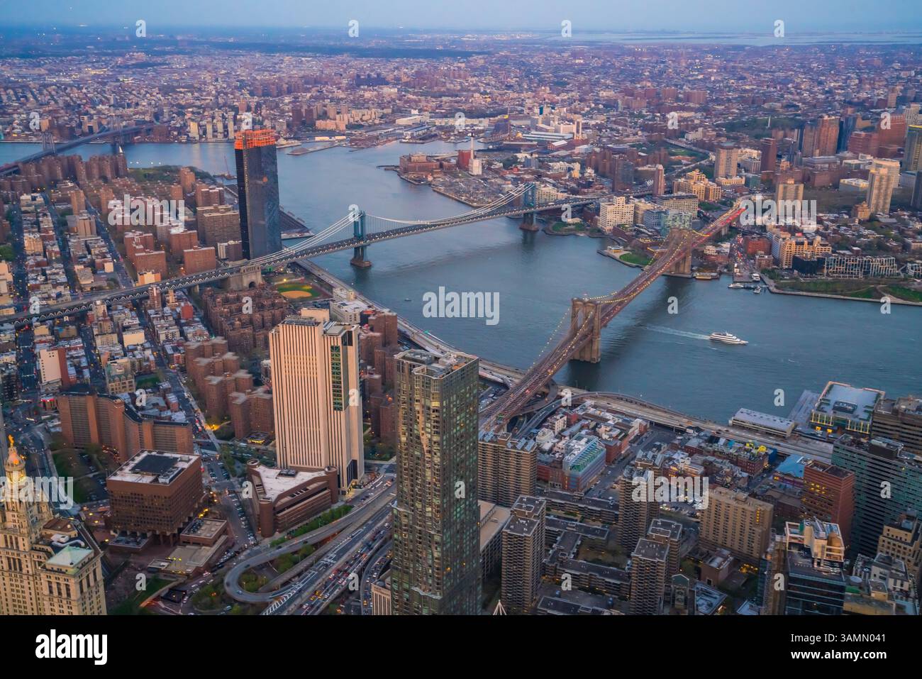 Aerial view of Manhattan skyline with Brooklyn Bridge over East River ...