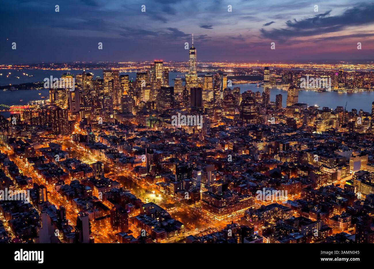 Aerial view of Manhattan at night with illuminated skyscrapers and city ...