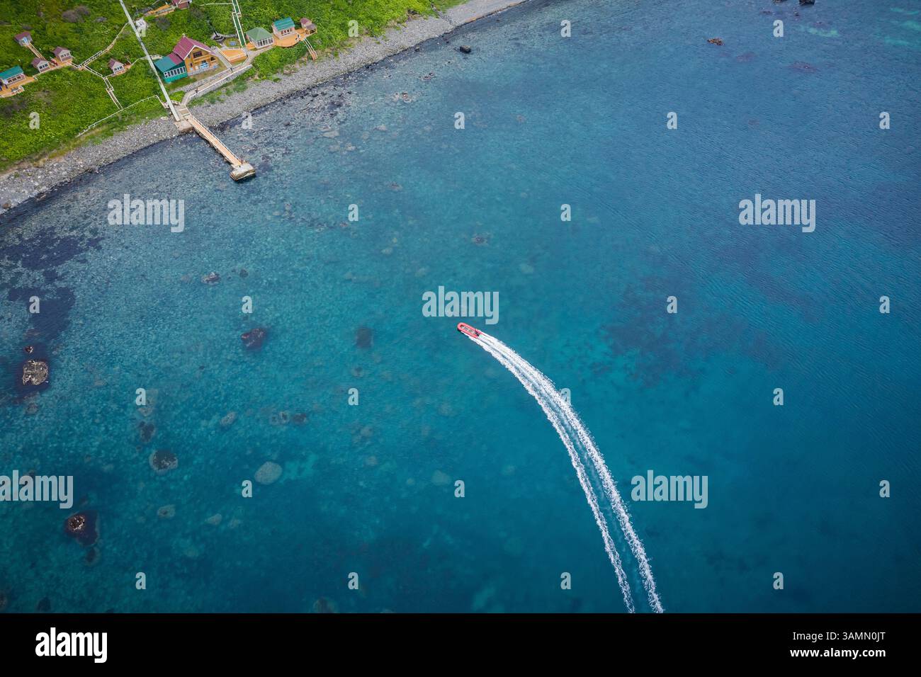 Aerial view of a boat sailing along Ostrov Moneron island, Nevelsk ...