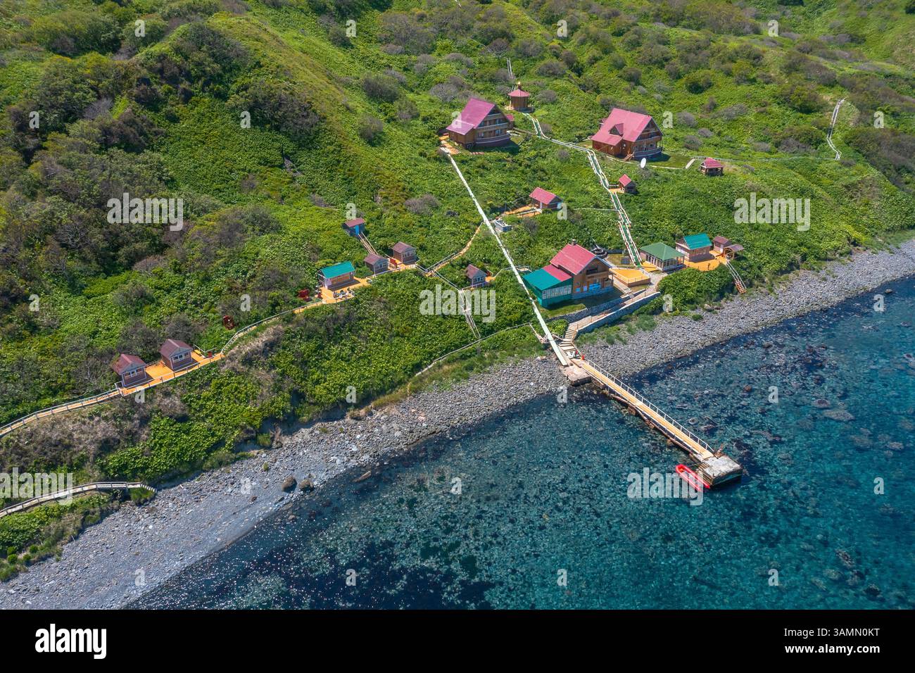 Aerial panoramic view of a pier and promontory on Ostrov Moneron island ...