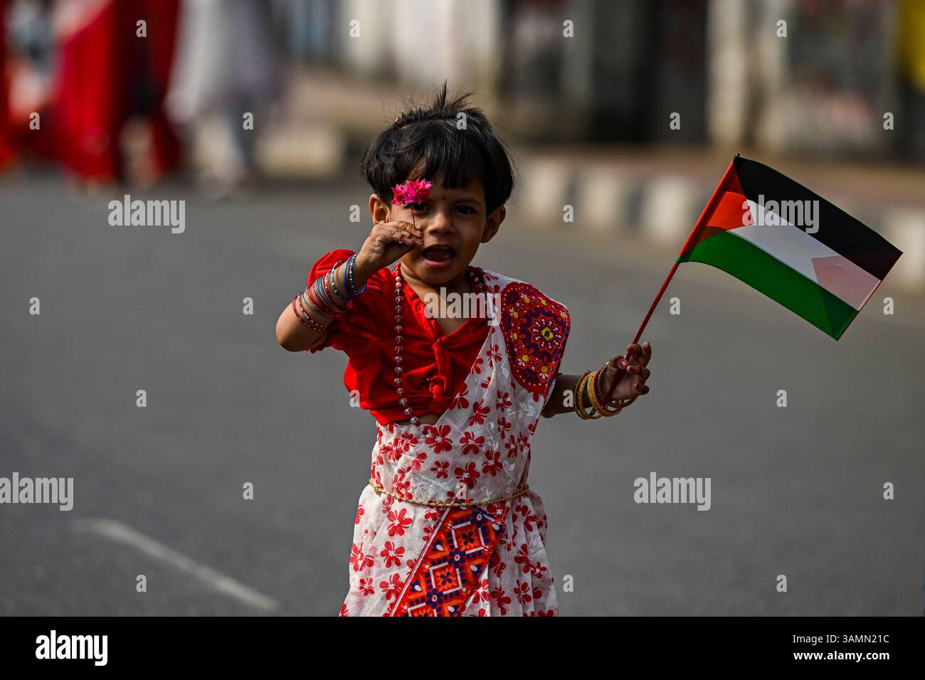 Dhaka, Bangladesh. 14th Apr, 2025. A baby girl marches down a street ...