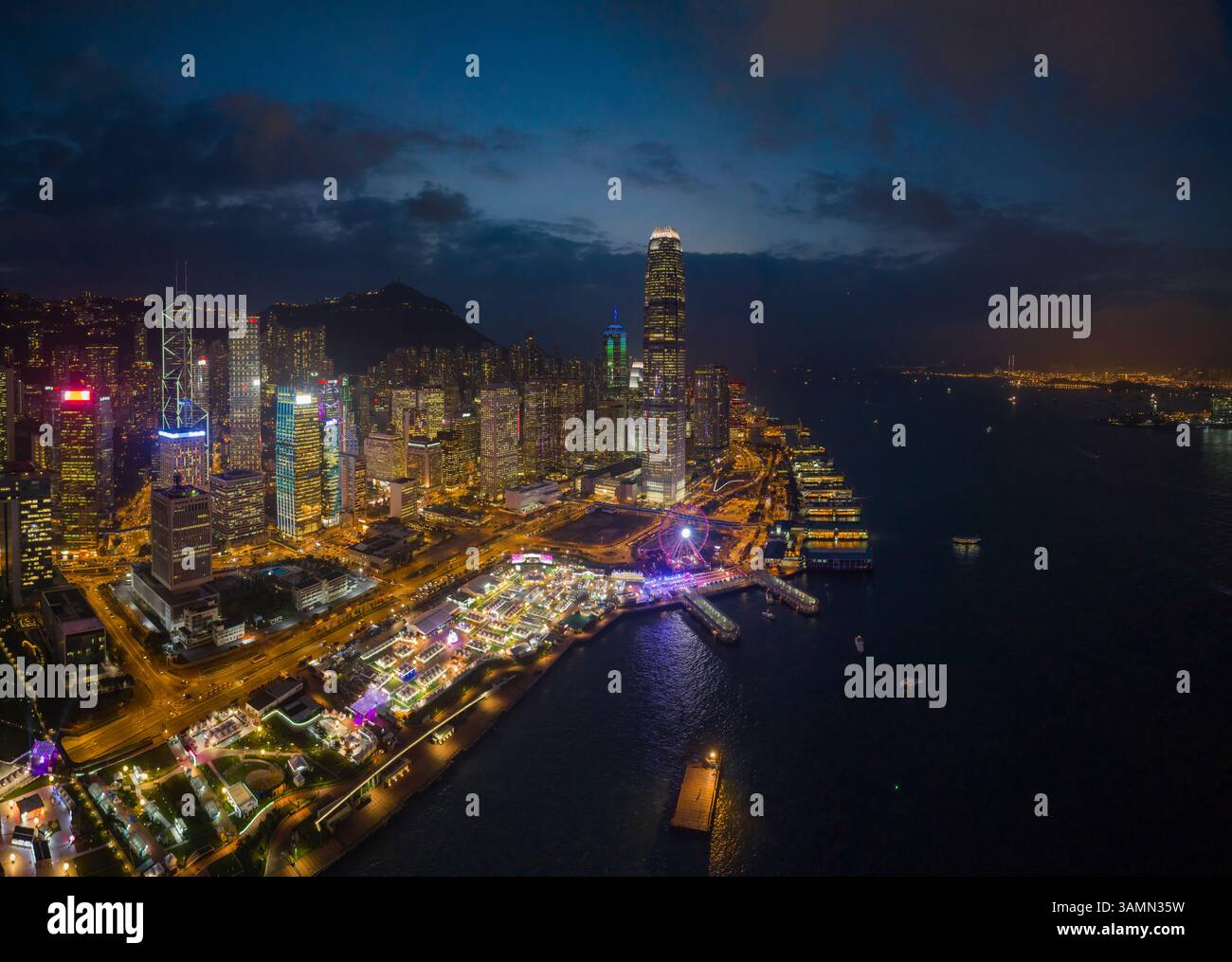 Aerial view of Hong Kong skyline with financial district at night along ...