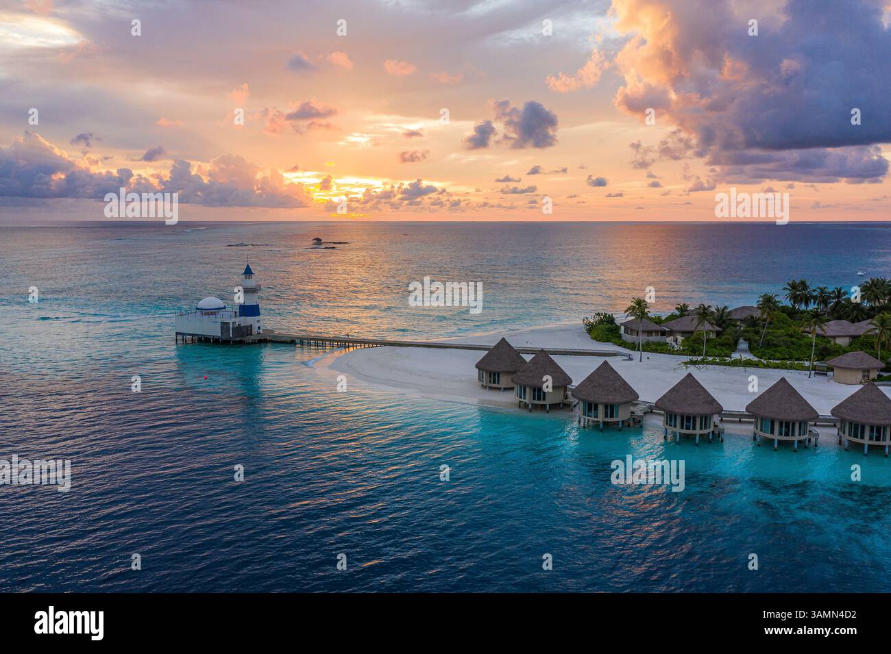 Aerial view of a lighthouse of a luxury resort with bungalows on a ...