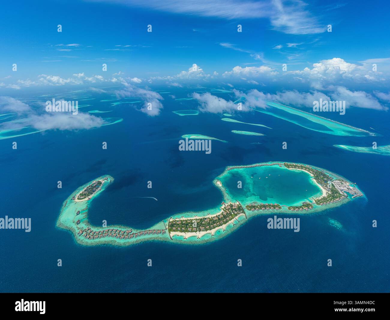 Aerial view of Ithaafushi Island with low clouds, Maldives archipelagos ...