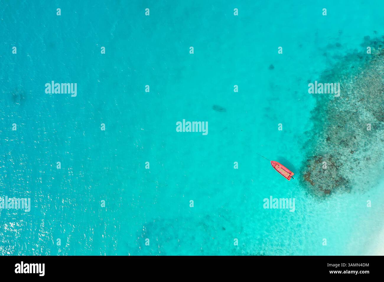 Aerial view of a small fishing boat along the reef in Guraidhoo ...