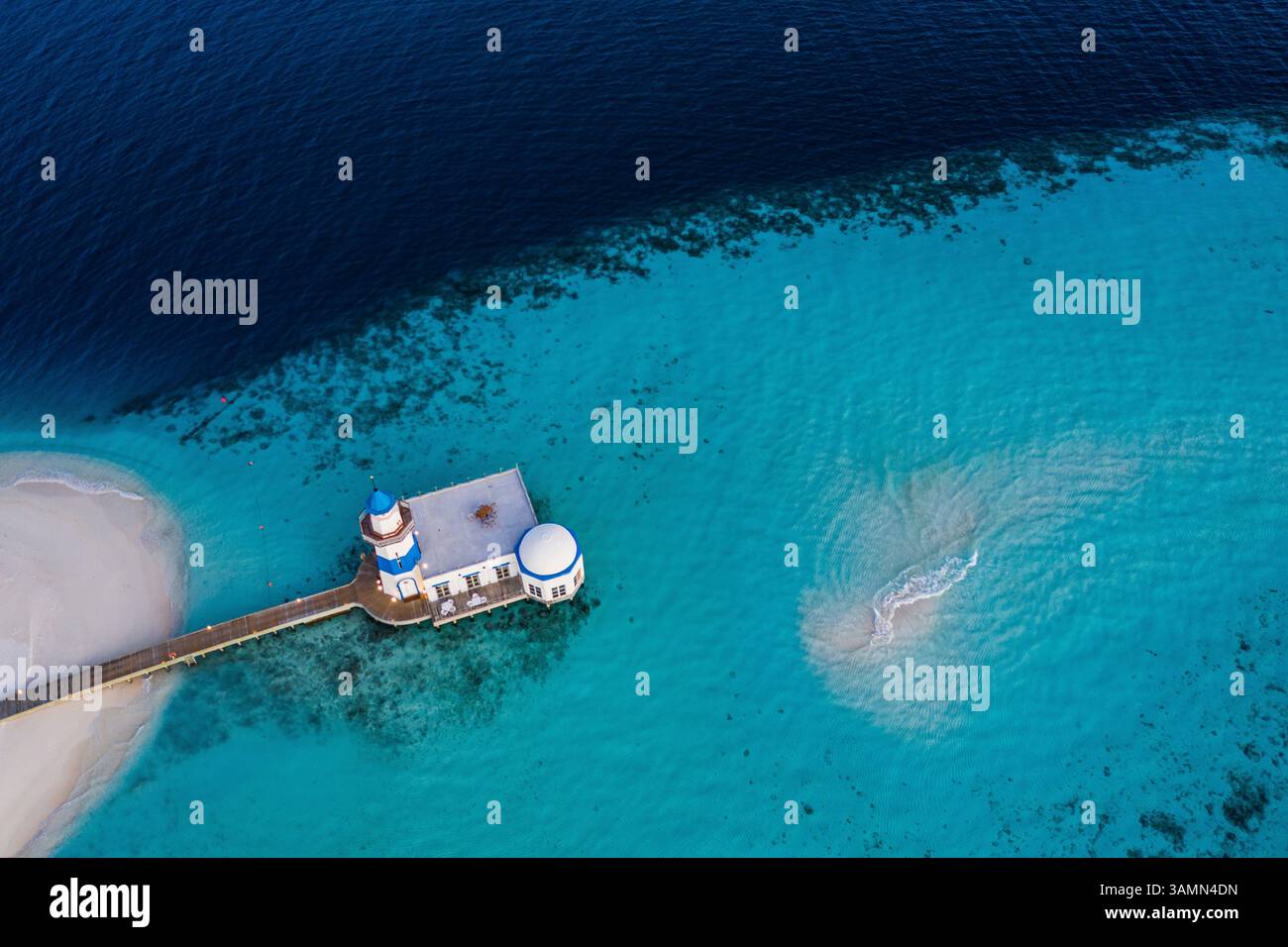 Aerial view of a lighthouse of a luxury resort with bungalows on a ...