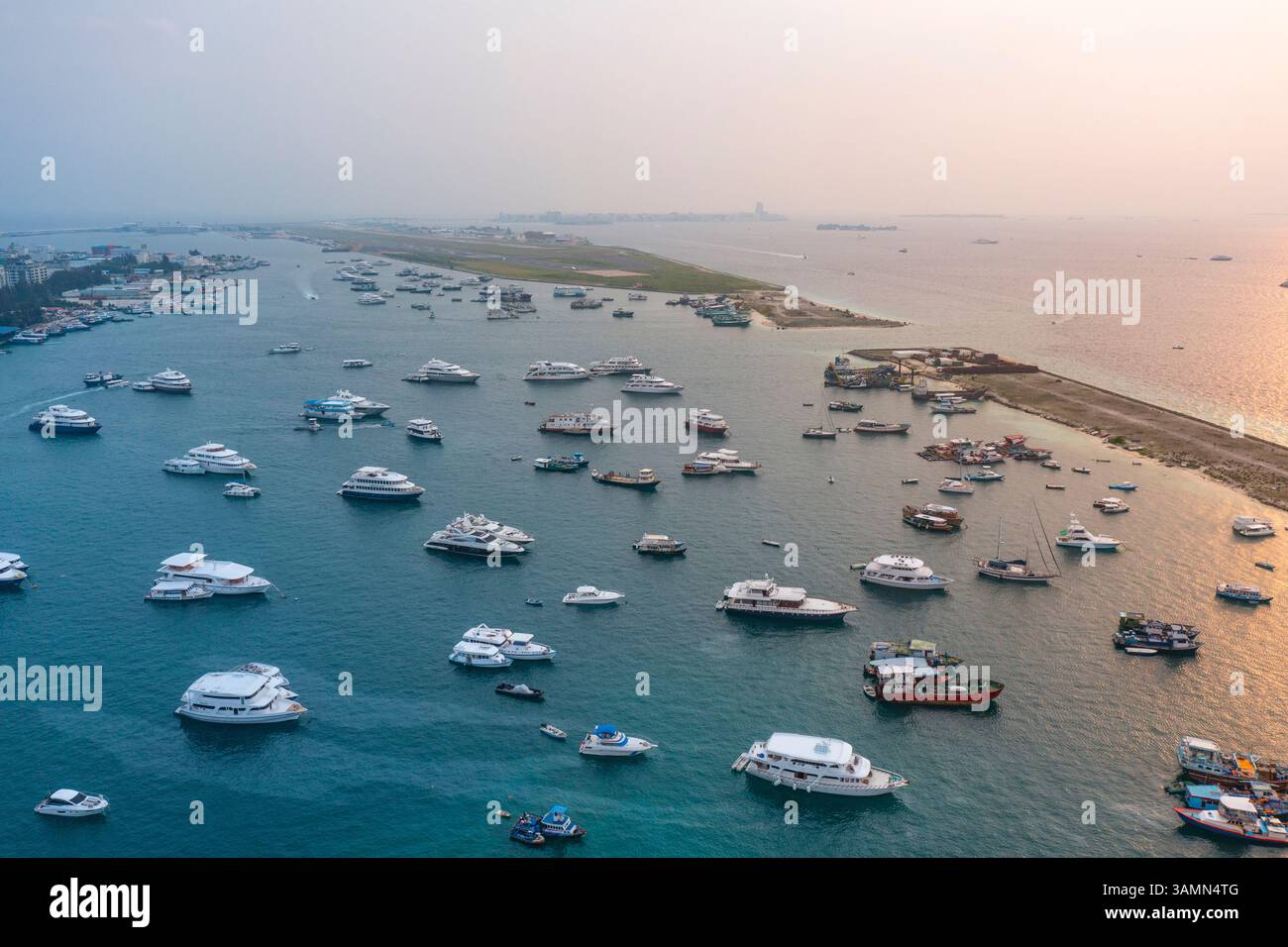 Aerial view of sailing boats at Malè harbour at sunset, Maldives ...