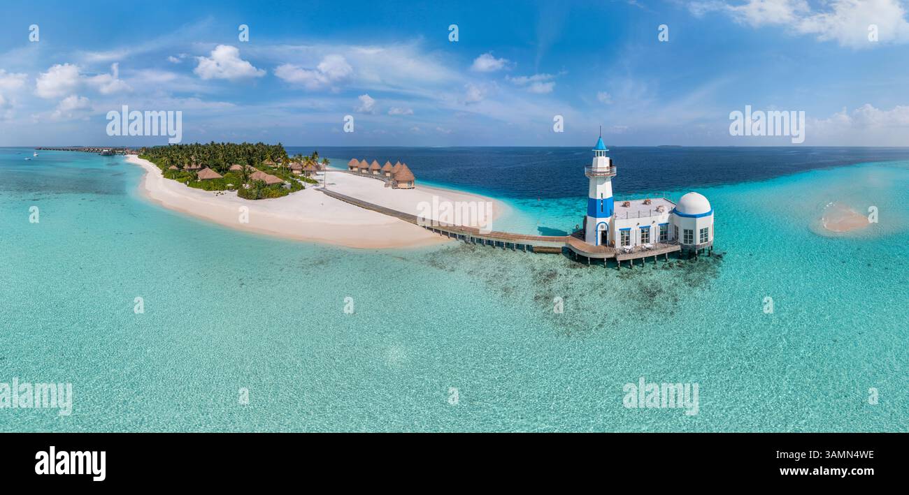 Aerial view of a lighthouse of a luxury resort with bungalows on a ...