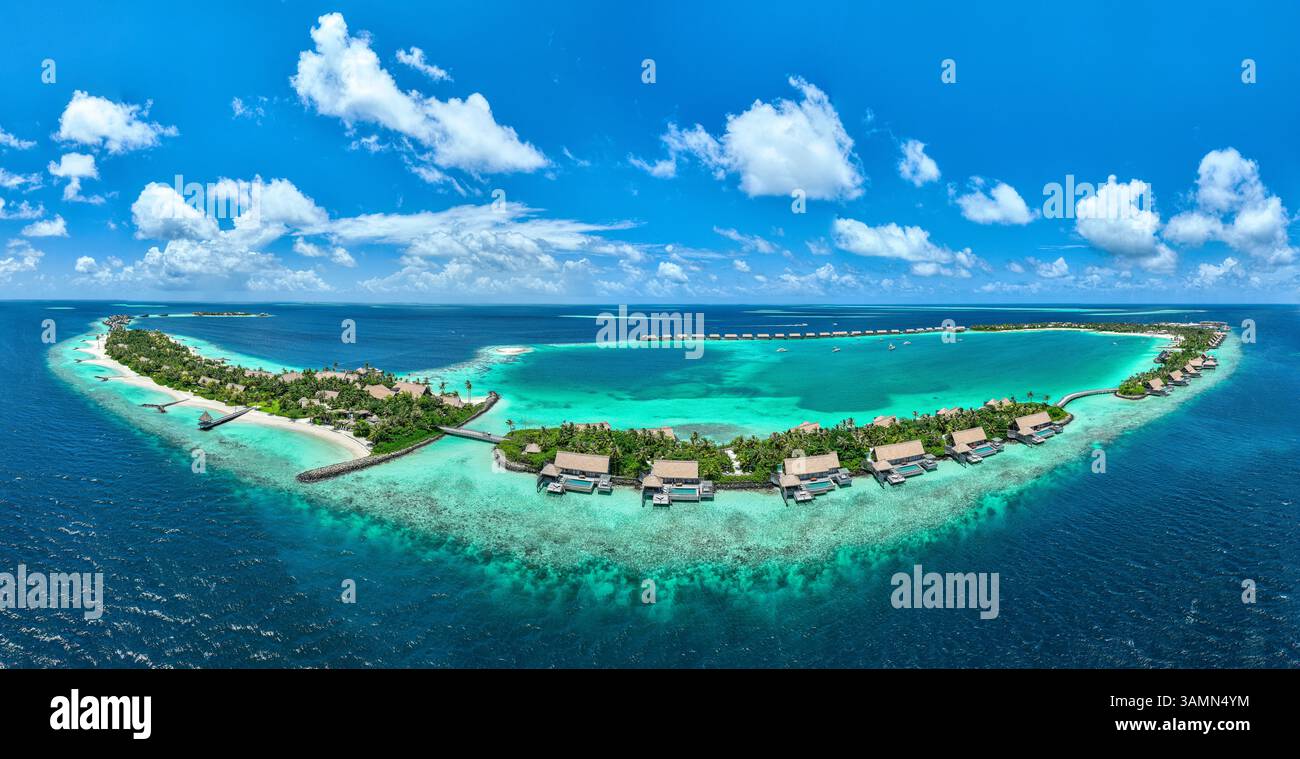 Panoramic aerial view of bungalows along the shore on Ithaafushi Island ...