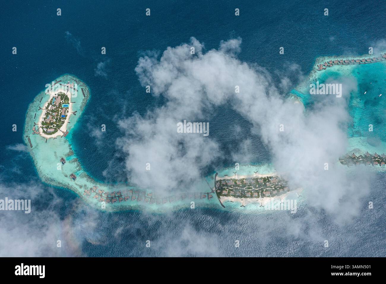 Aerial view of Ithaafushi Island with low clouds, Maldives archipelagos ...