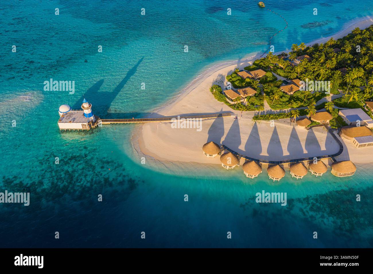 Aerial view of a lighthouse of a luxury resort with bungalows on a ...