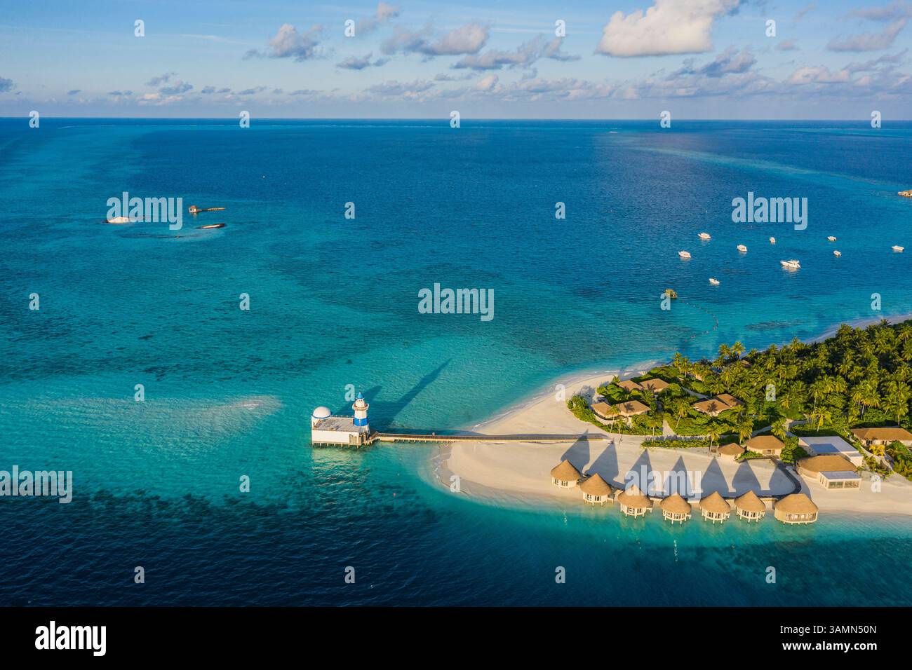 Aerial view of a lighthouse of a luxury resort with bungalows on a ...