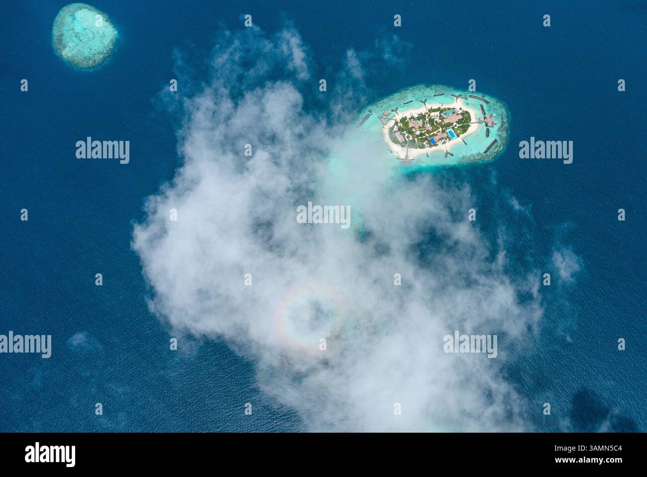 Aerial view of Ithaafushi Island with low clouds, Maldives archipelagos ...