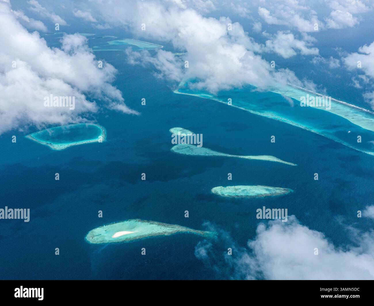 Aerial view of Ithaafushi Island and Atolls with low clouds, Maldives ...