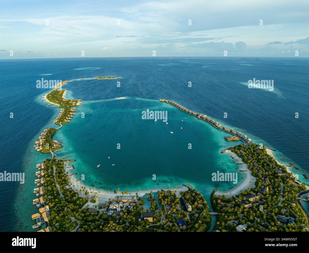 Aerial view of bungalows along the shore on Ithaafushi Island, Maldives ...