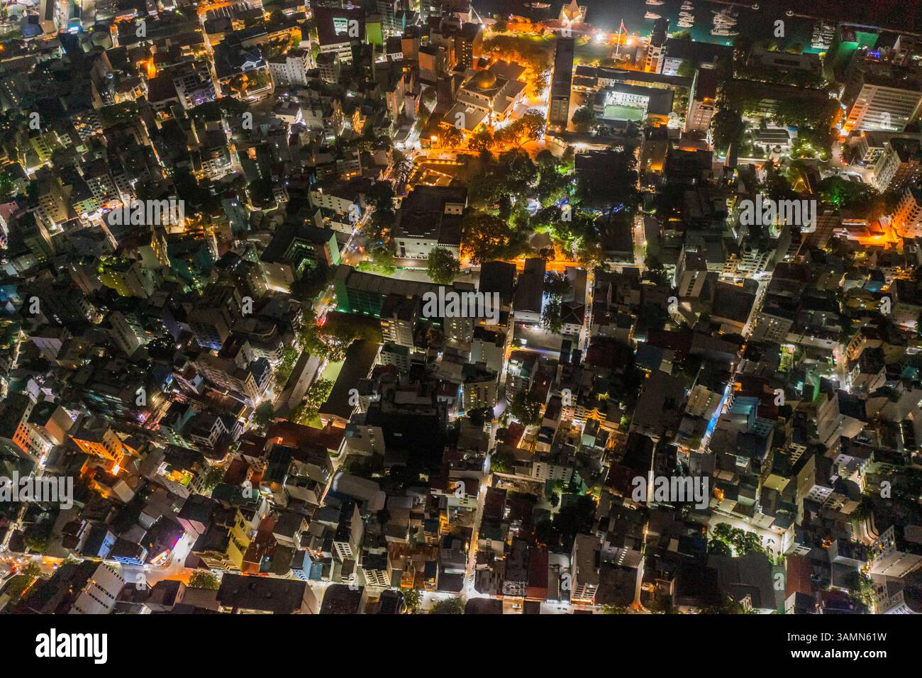 Aerial view of buildings at night in Malè Town, Maldives archipelagos ...