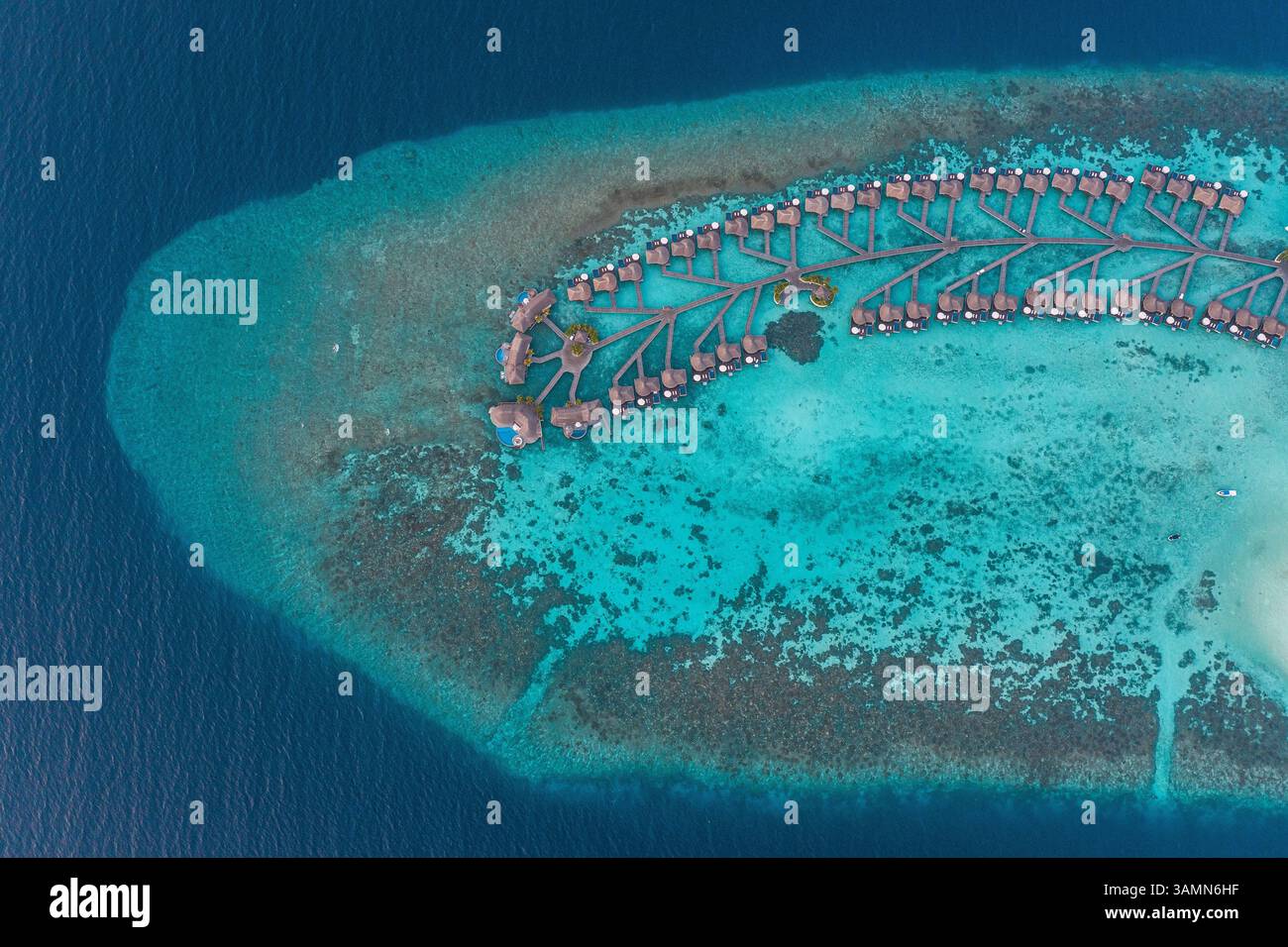 Aerial view of bungalows of a luxury resort along the reef on Fesdhoo ...