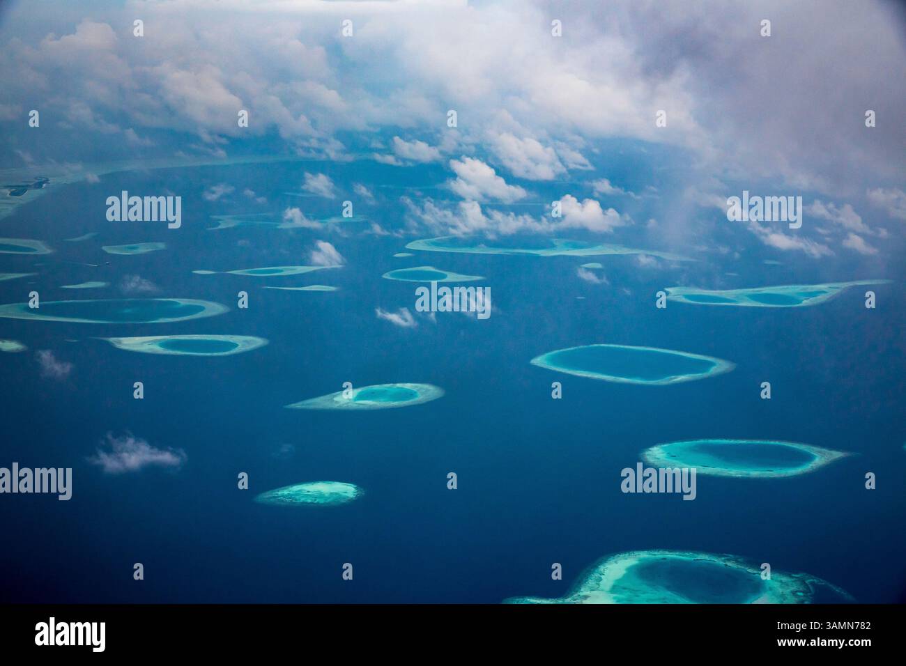 Aerial view of Atolls in Maldives archipelagos in the Indian Ocean with ...