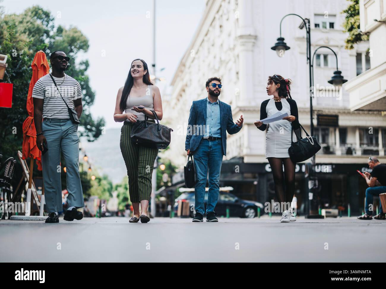 Diverse business professionals walking together in urban setting Stock ...