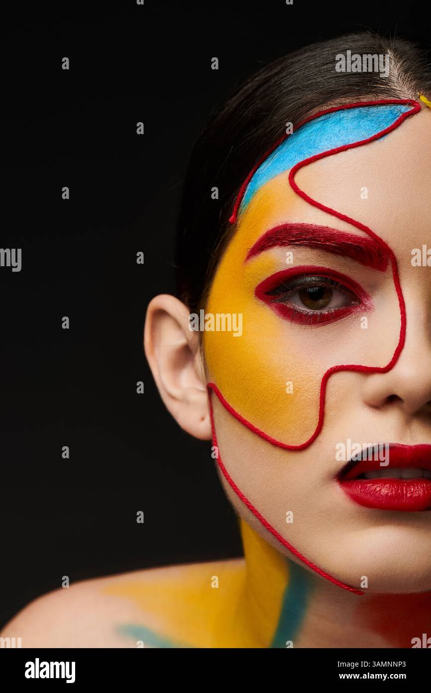 A young beautiful woman showcases vibrant face art that enhances her ...