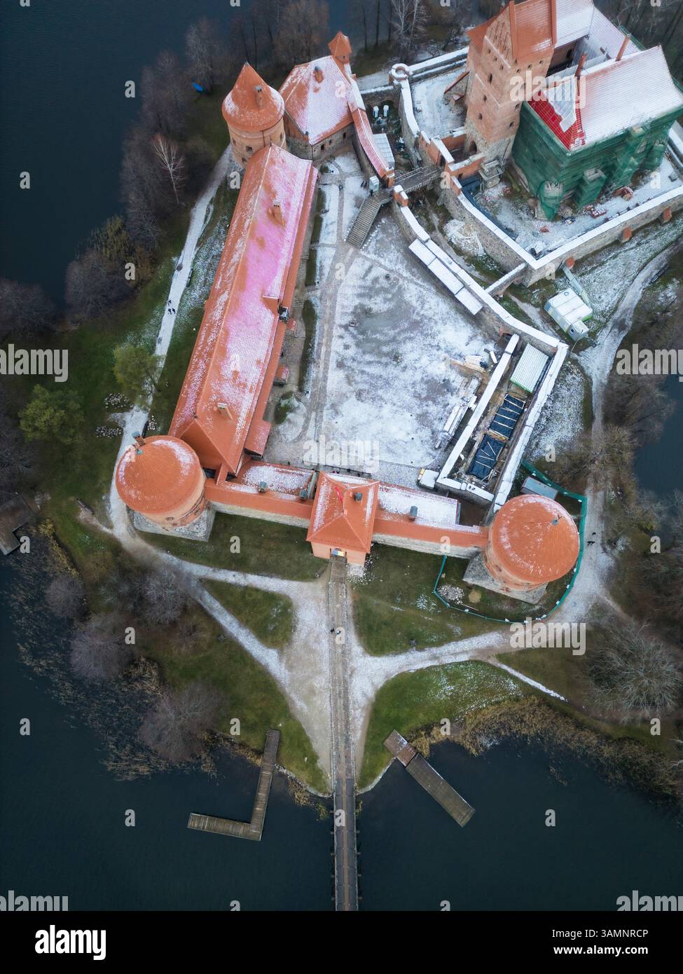 Aerial view of Trakai Castle surrounded by a scenic lake and snow ...