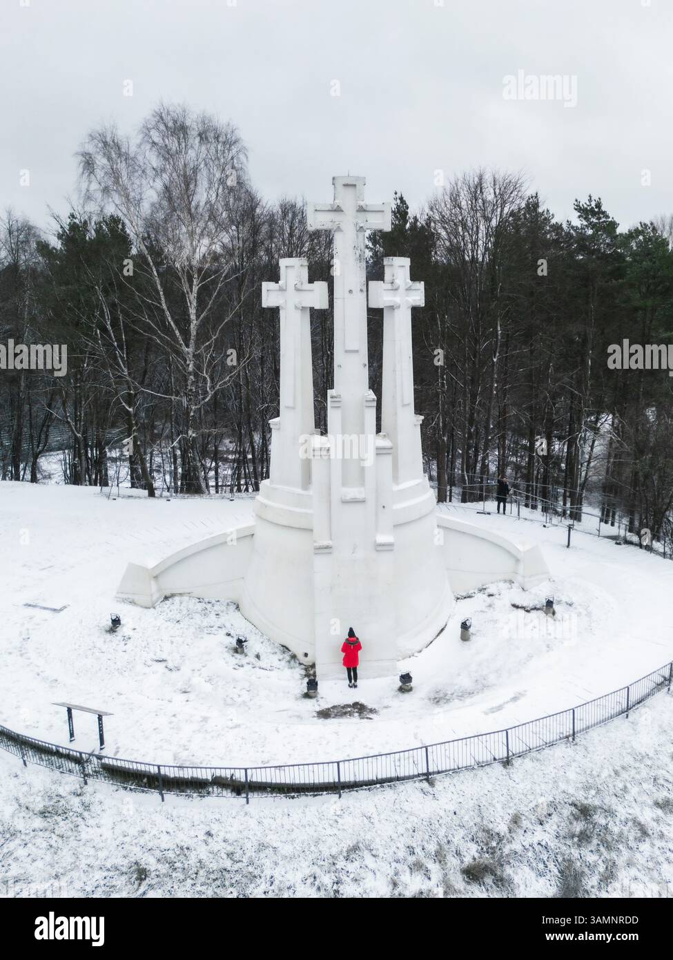 Aerial view of three crosses monument surrounded by snow-covered trees ...