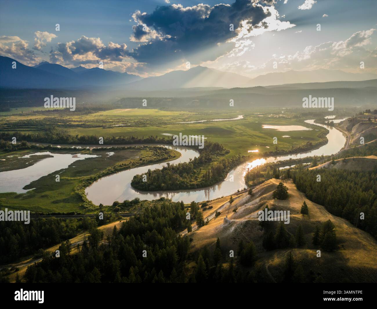 Aerial view of serene wetlands and majestic mountains along the ...