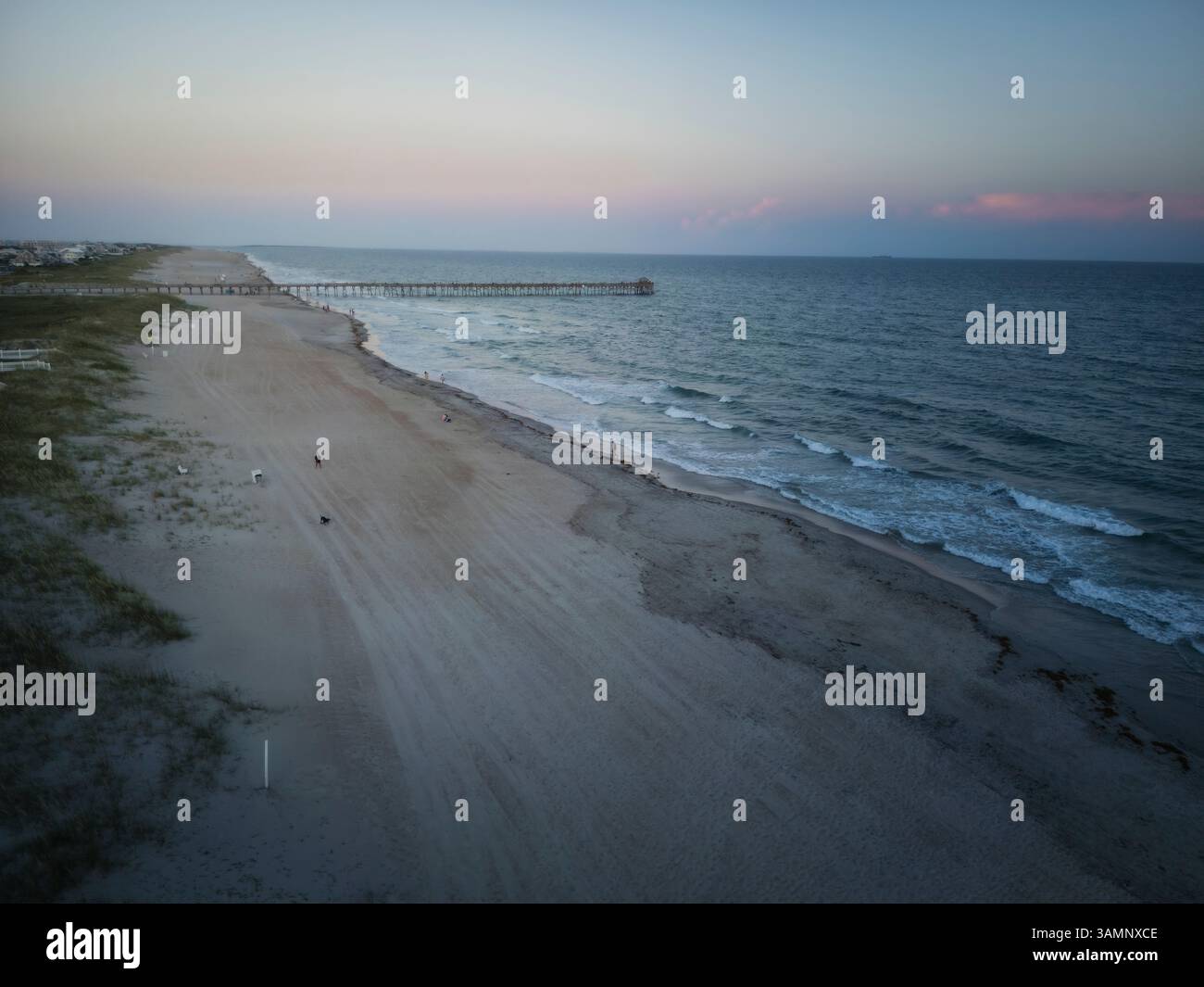 Aerial view of serene Atlantic Beach with people enjoying the sandy ...