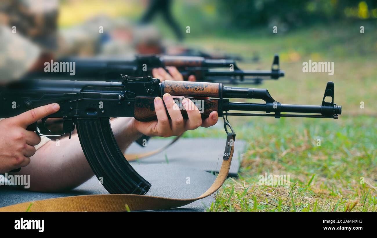 Close-up of Soldiers Practicing Shooting with Rifles on Grass. Soldiers ...