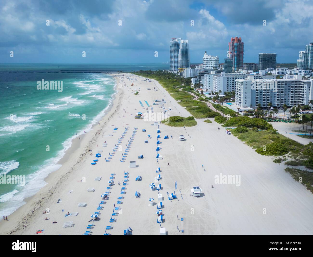 Aerial view of a vibrant beach scene with lifeguard house, beach chairs ...