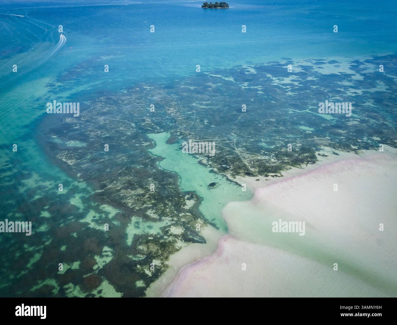 Aerial view of colorful coral reef and sandbanks at hurricane pass ...