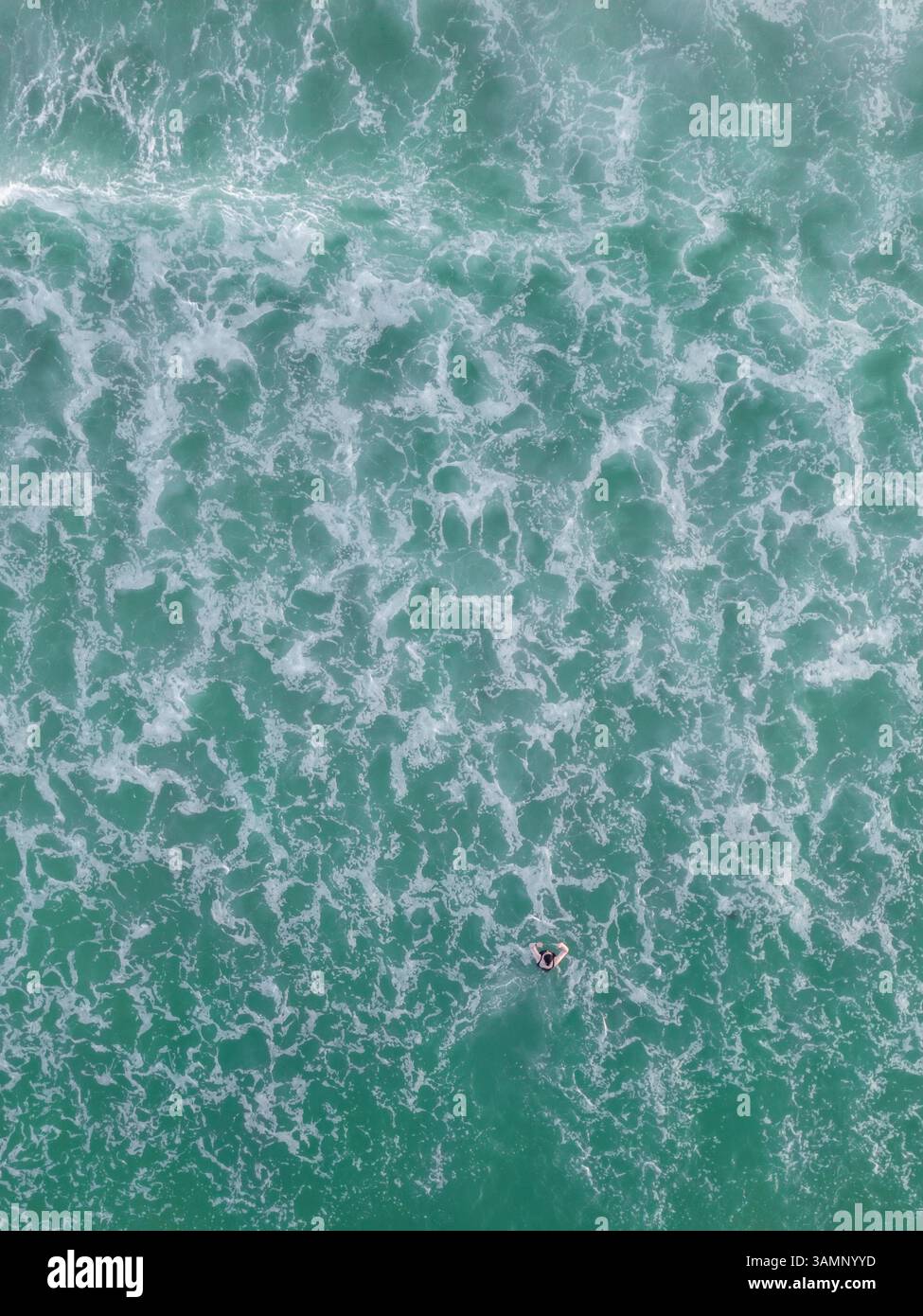 Aerial view of one person surfing on beautiful waves in the gulf of ...
