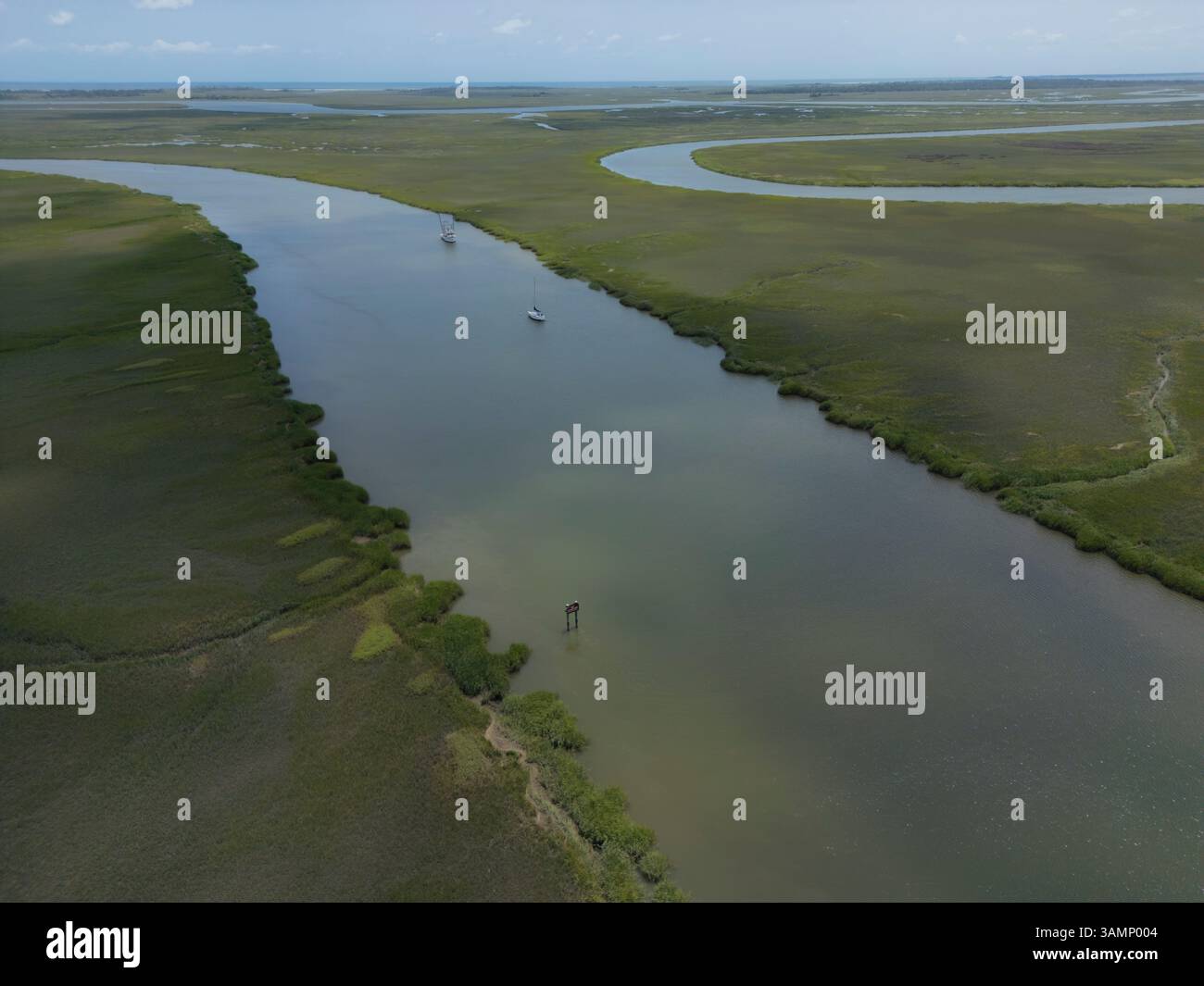 Aerial view of a tranquil river with two boats surrounded by beautiful ...
