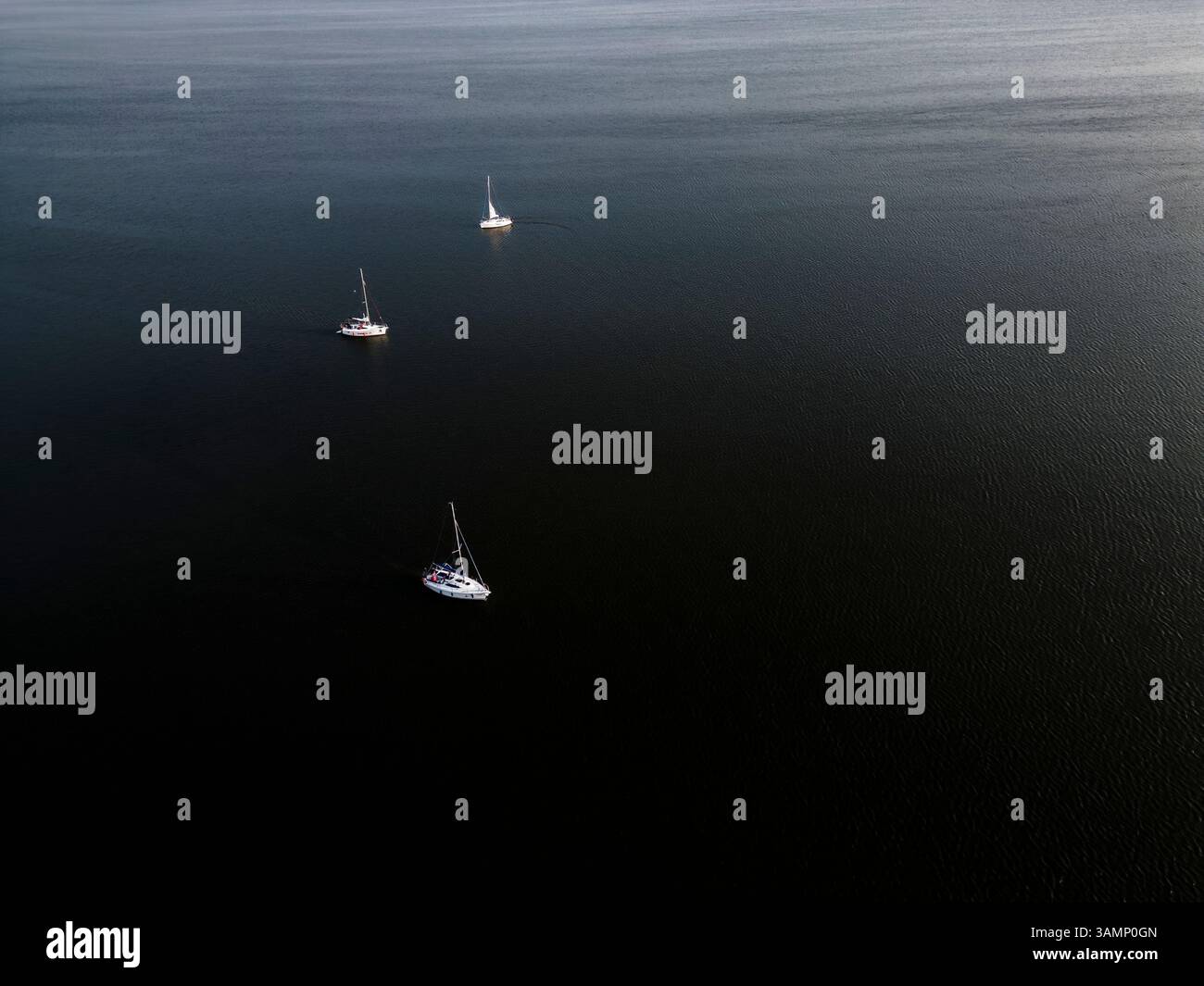 Aerial view of tranquil lake Zbaszynskie with three boats, Zbaszyn ...