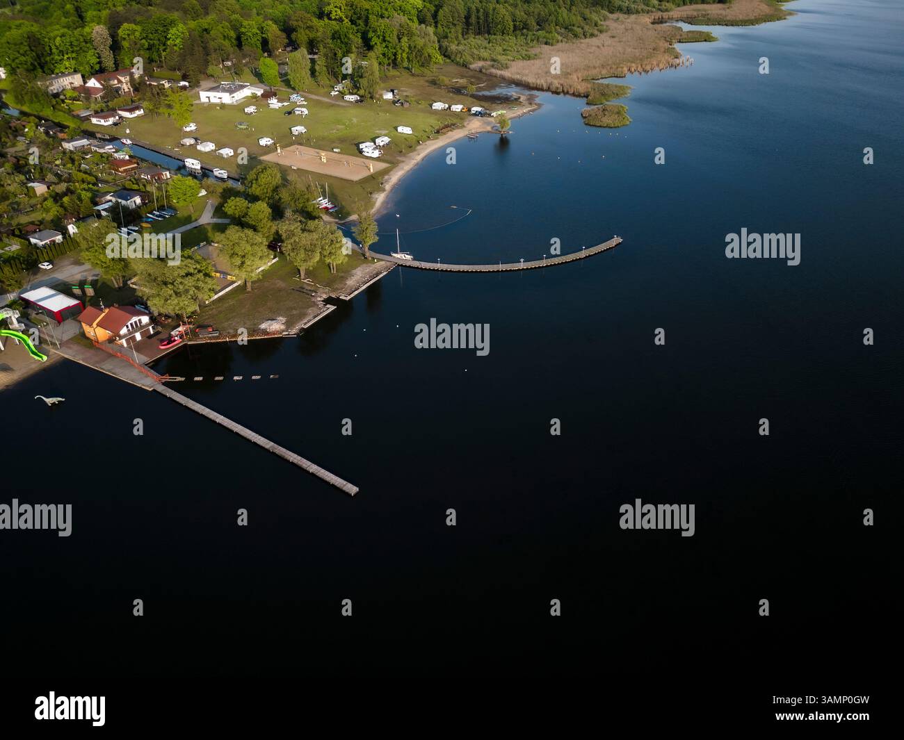 Aerial view of tranquil lake Zdaszynskie with piers and campground ...