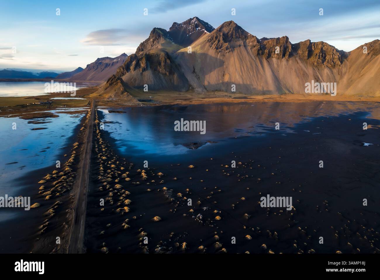 Aerial view of rugged coastal formation with majestic mountains and ...