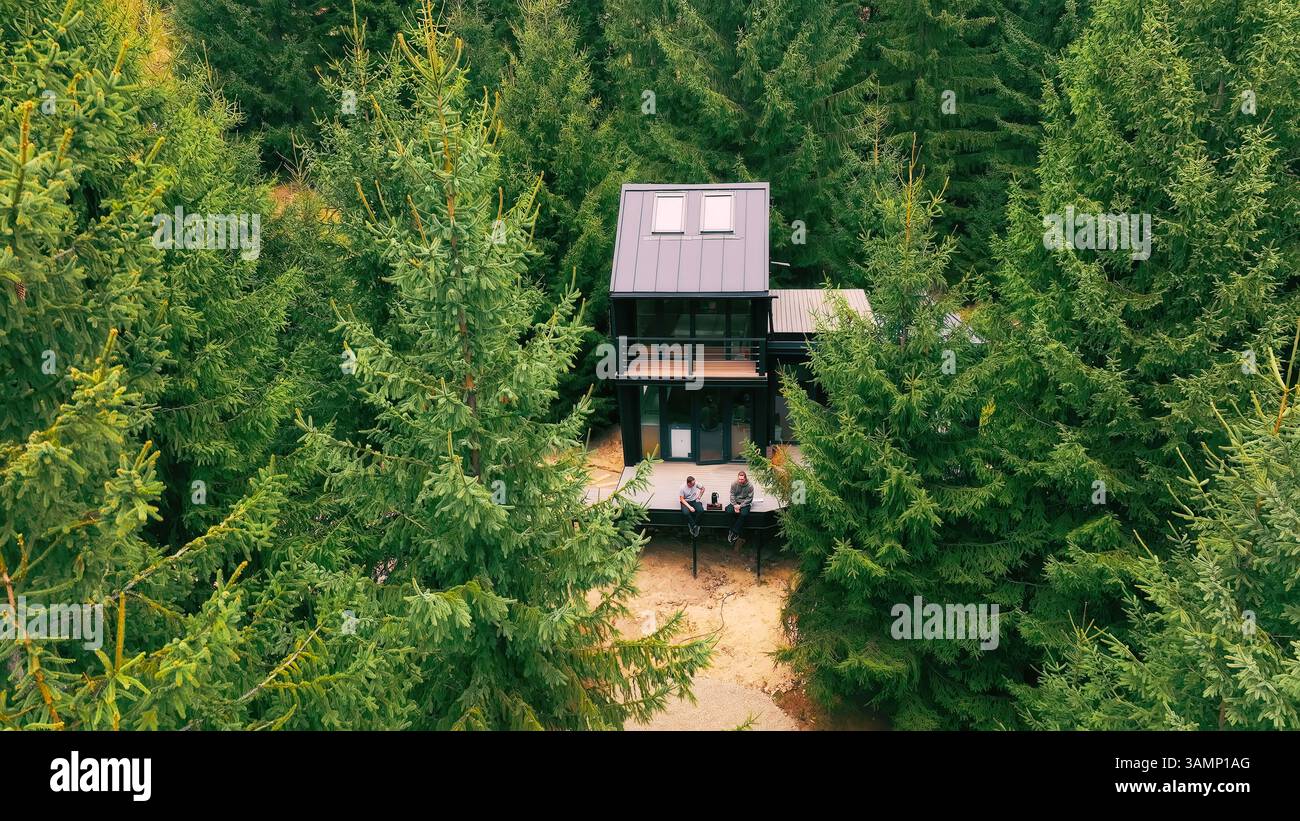 A modern house surrounded by a dense forest. Aerial view of a modern ...