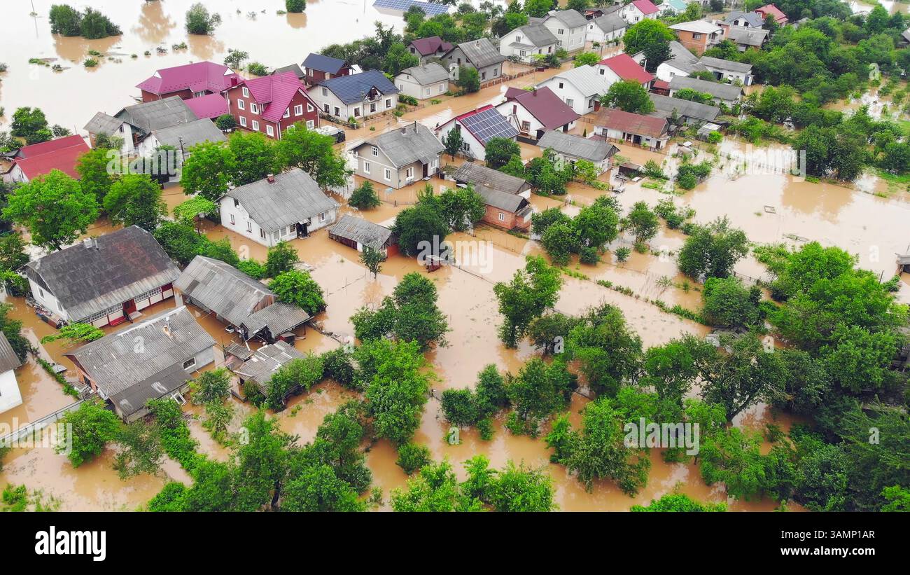 Flooded Neighborhood with Submerged Homes and Trees. Aerial view of a flooded residential area ...
