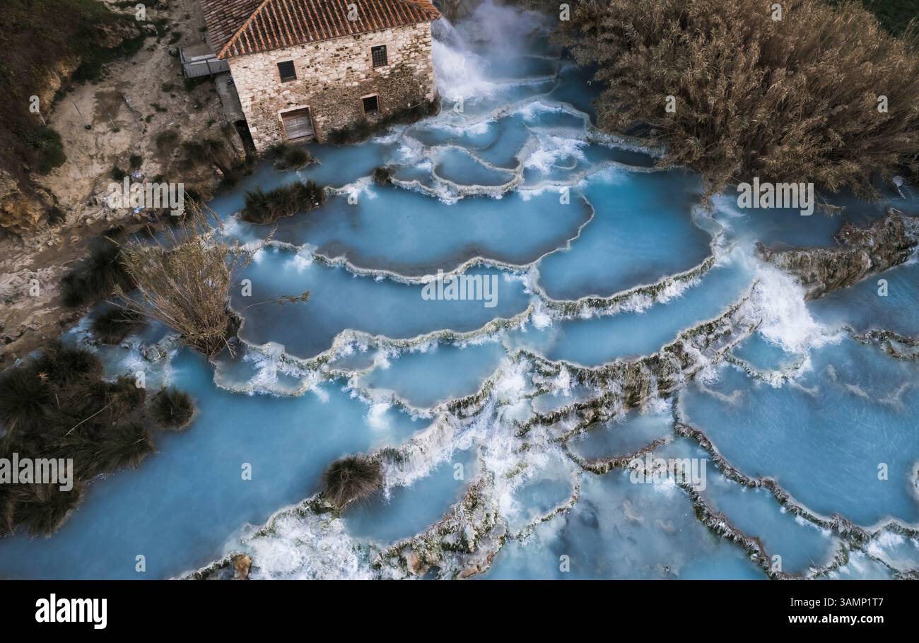 Aerial view of cascading pools and historic building at Terme di ...