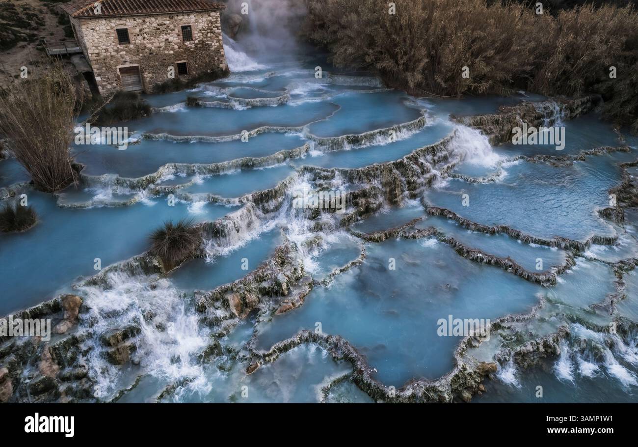 Aerial view of Tempak Waterfall and natural pools with stone building ...