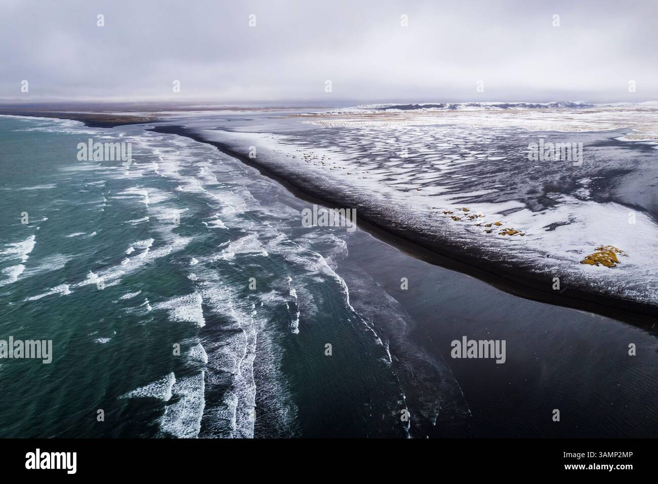 Aerial view of snowy coast and sea in Vatnsnes peninsula, Atlantic ...