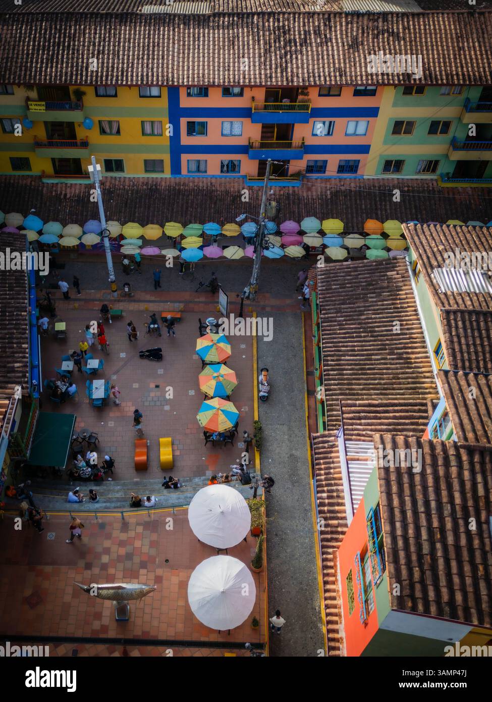 Aerial view of colorful buildings and people in courtyard with ...