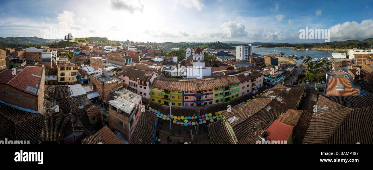 Aerial view of colorful buildings, rooftops, lake, and mountains in ...